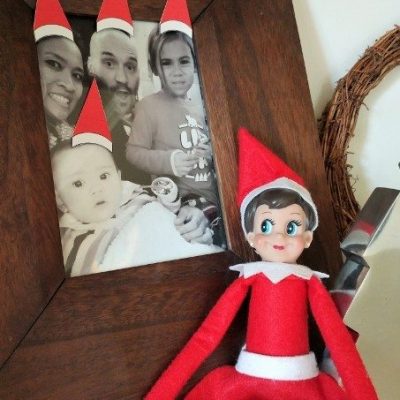 elf-on-the-shelf-ideas-santa-hat-family-picture - DIY Inspired
